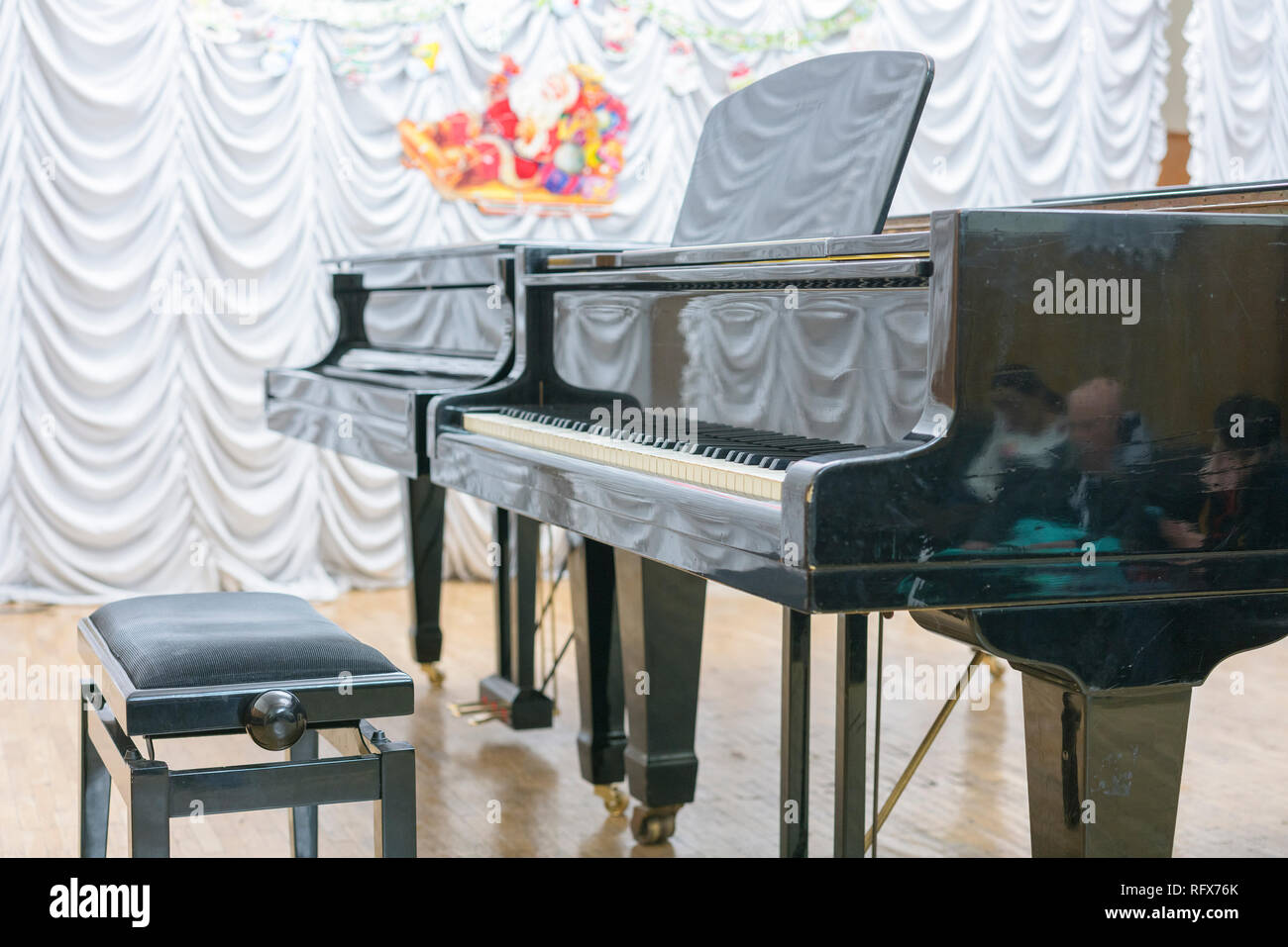 Two black grand pianos on stage. Two grand pianos on stage without no ...