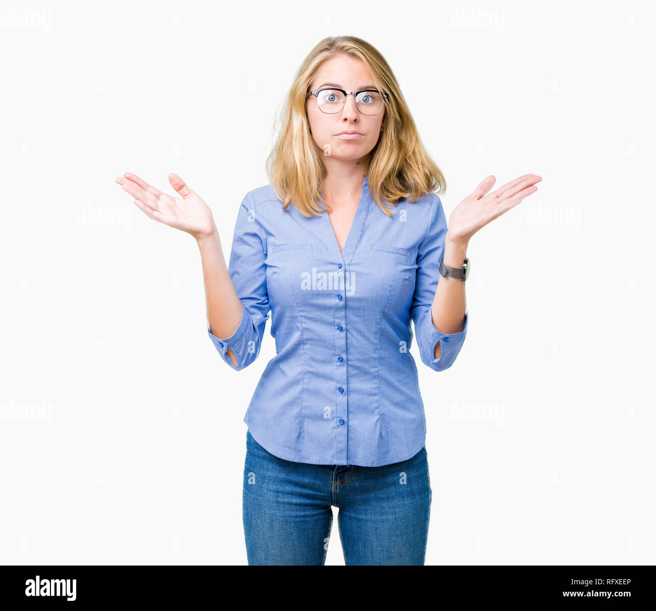Beautiful young business woman over isolated background clueless and ...