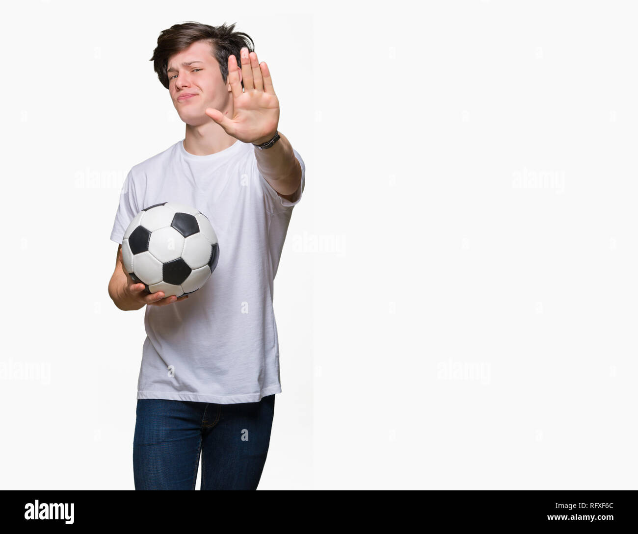 Young man holding soccer football ball over isolated background with ...