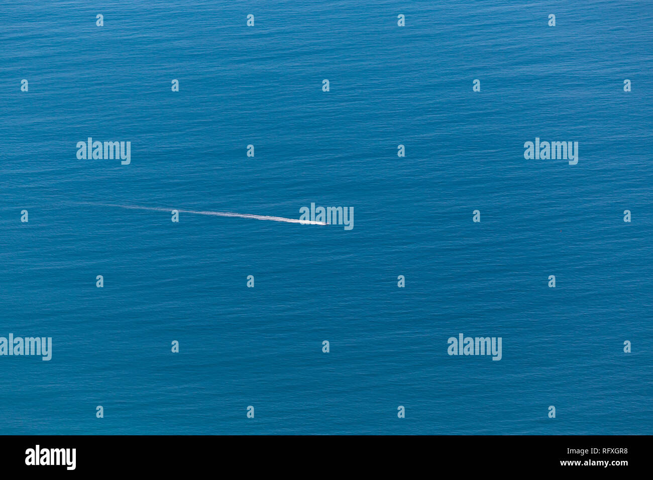 Aerial view of small boat flowing in the ocean, minimalistic travel ...