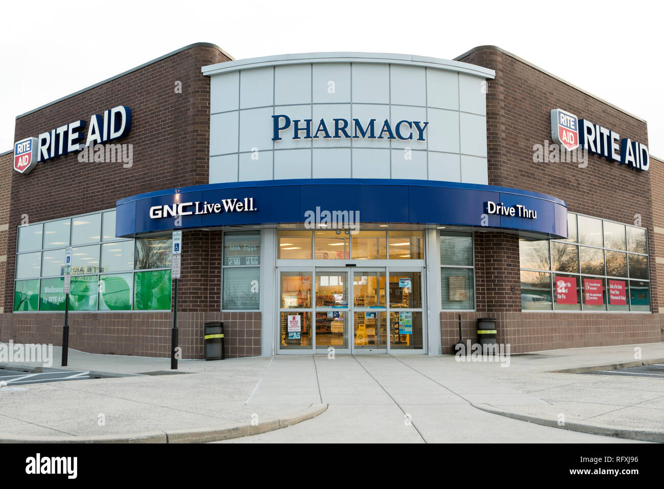 A logo sign outside of a Rite Aid pharmacy and retail store location in ...