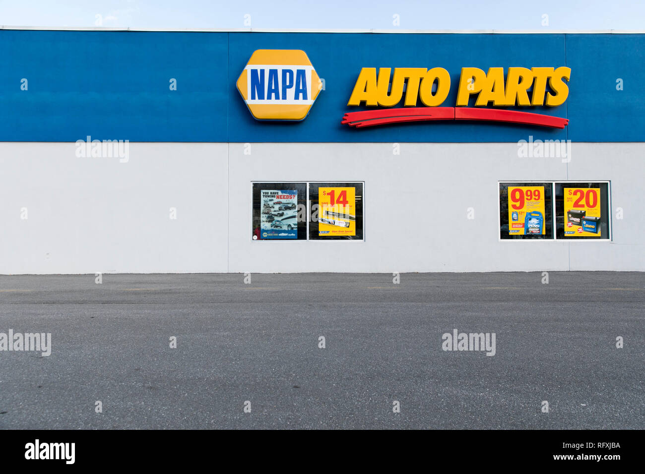 A logo sign outside of a NAPA Auto Parts retail store location in ...