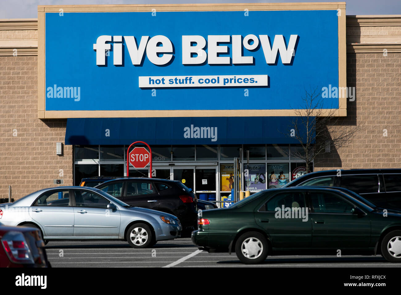 A logo sign outside of a Five Below retail store location in ...