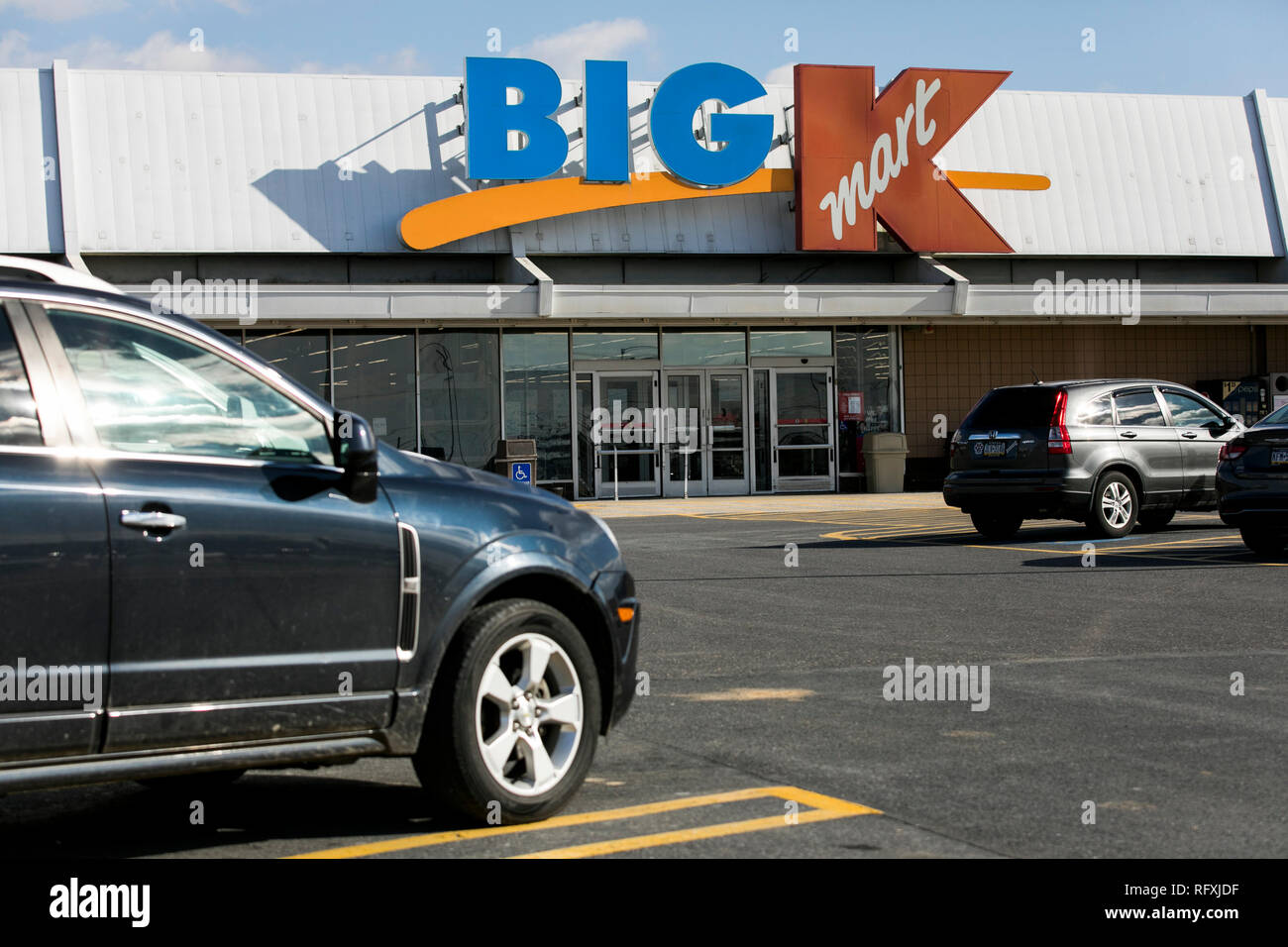 A logo sign outside of a Big Kmart retail store location in ...