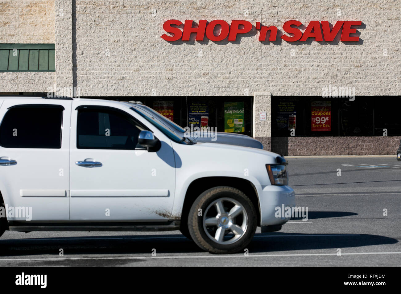 A logo sign outside of a SHOP 'n SAVE retail grocery store location in ...