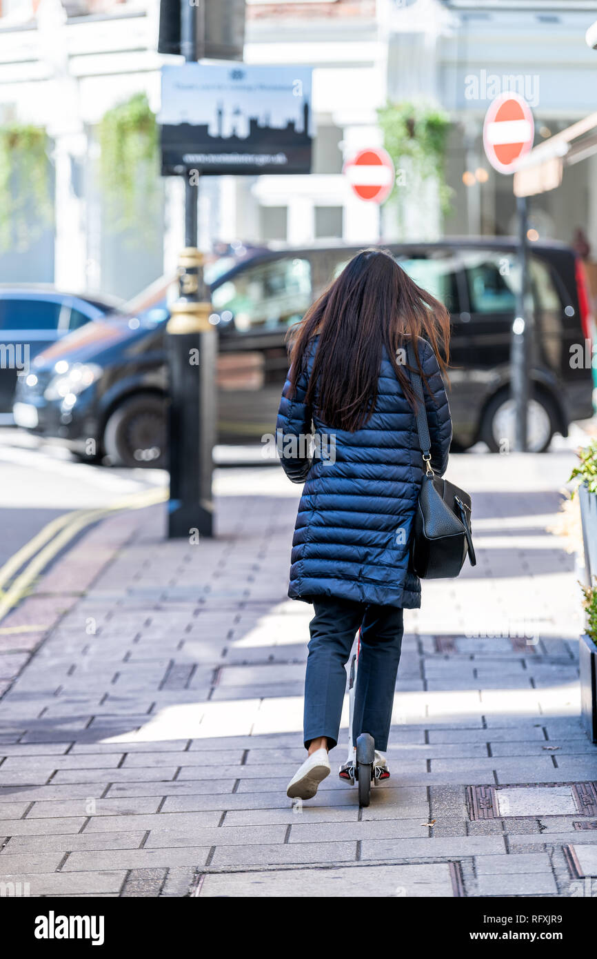 Adult riding scooter on pavement hi-res stock photography and images ...