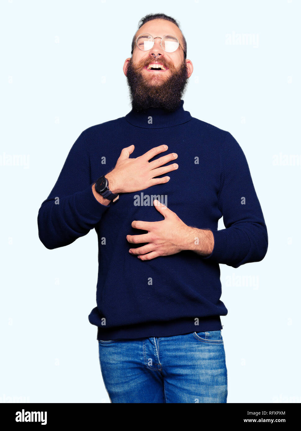 Young blond man wearing glasses and turtleneck sweater Smiling and ...