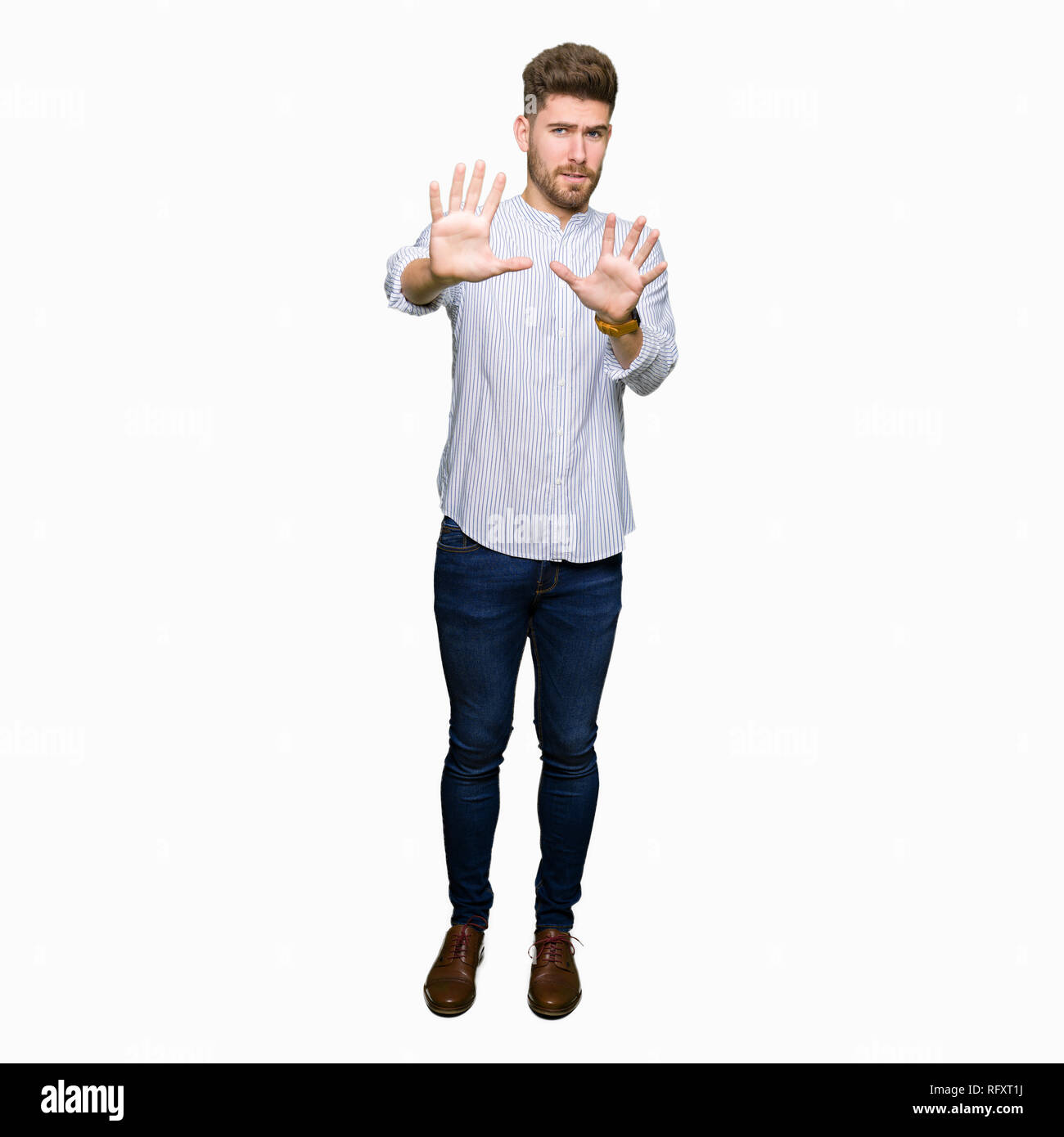 Young handsome man afraid and terrified with fear expression stop ...