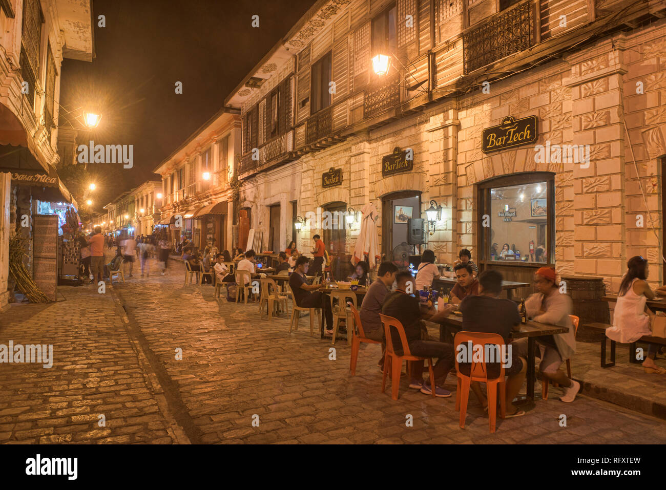 Tourists enjoying dinner on atmospheric Calle Crisologo in UNESCO World ... Tourists enjoying dinner on atmospheric Calle Crisologo in UNESCO World ...