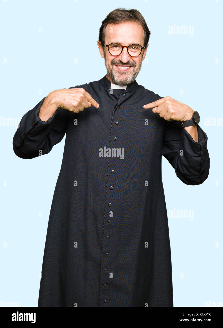 Middle age priest man wearing catholic robe looking confident with ...
