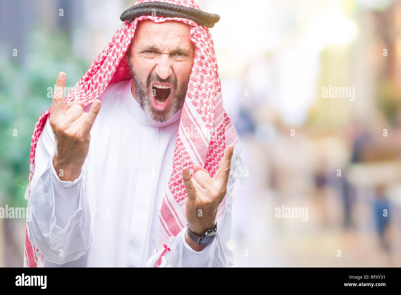 Senior arab man wearing keffiyeh over isolated background shouting with ...