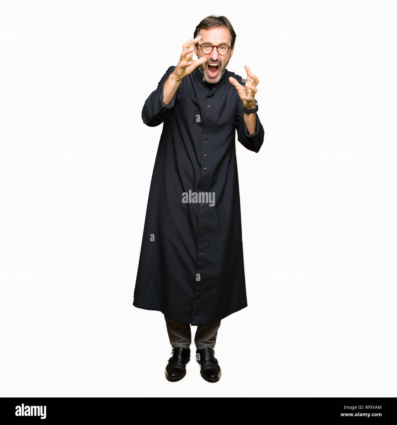 Middle age priest man wearing catholic robe Shouting frustrated with ...