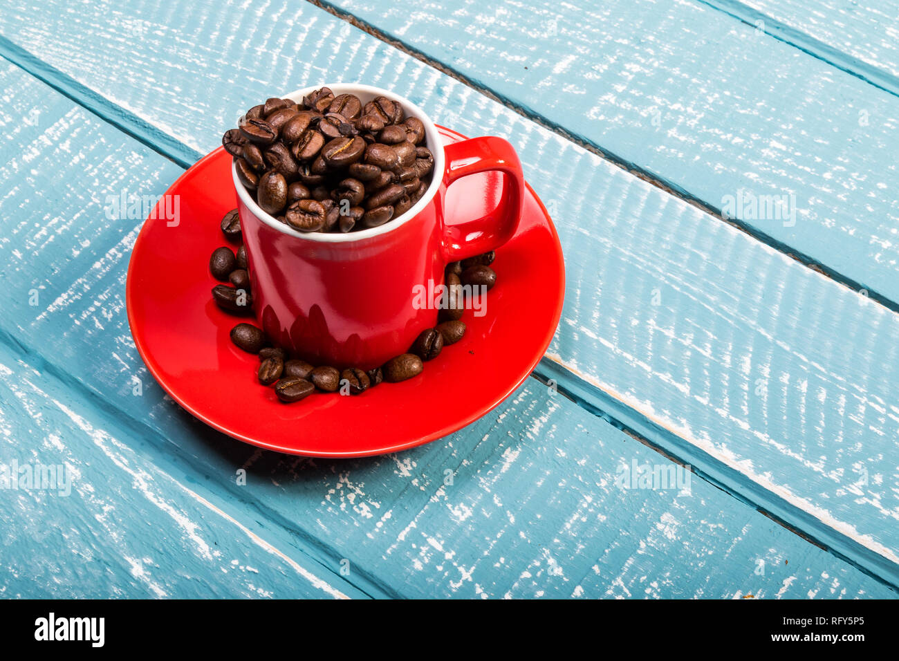 An espresso cup full of coffee beans on a weathered table Stock Photo ...