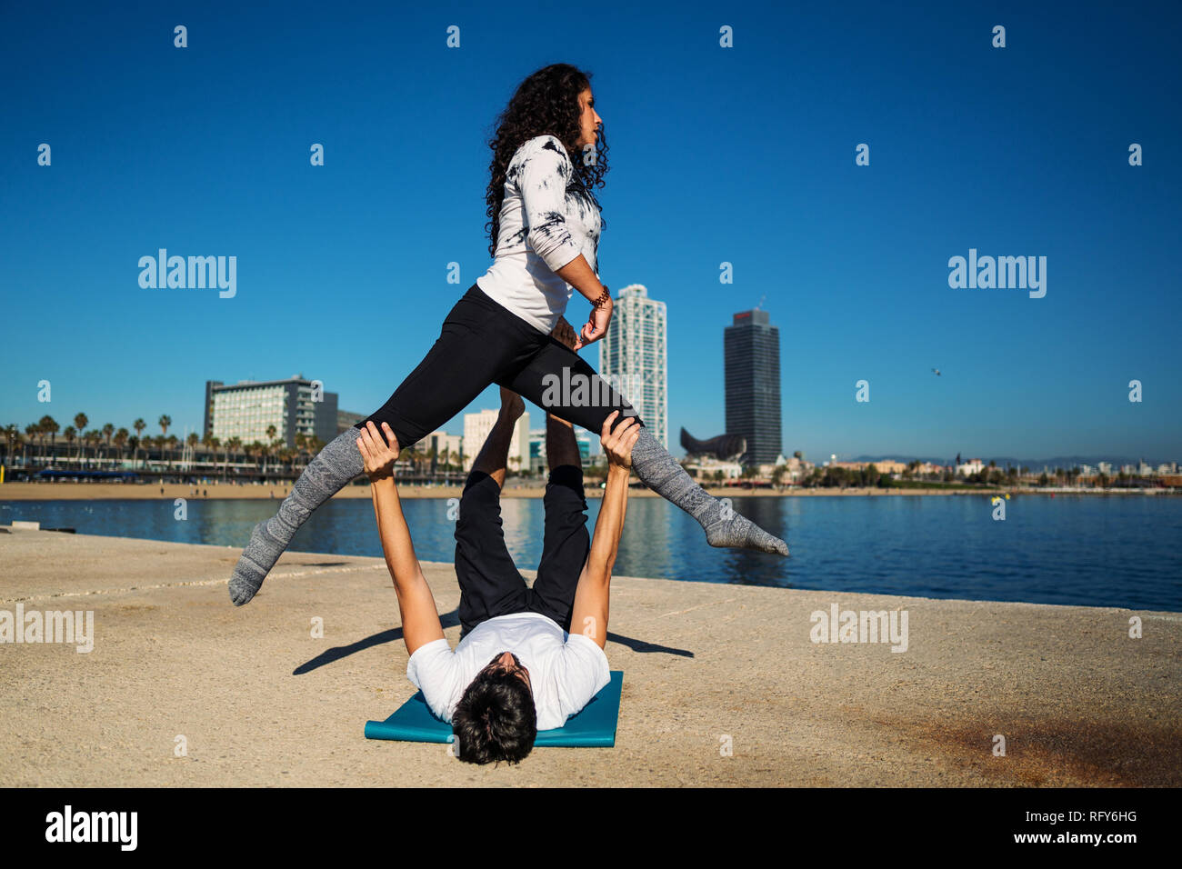 Couple in yoga pose hi-res stock photography and images - Alamy