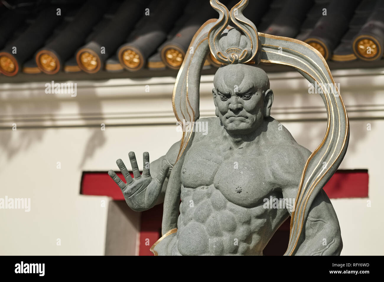 A fierce temple guardian statue outside the Buddha Tooth Temple and ...