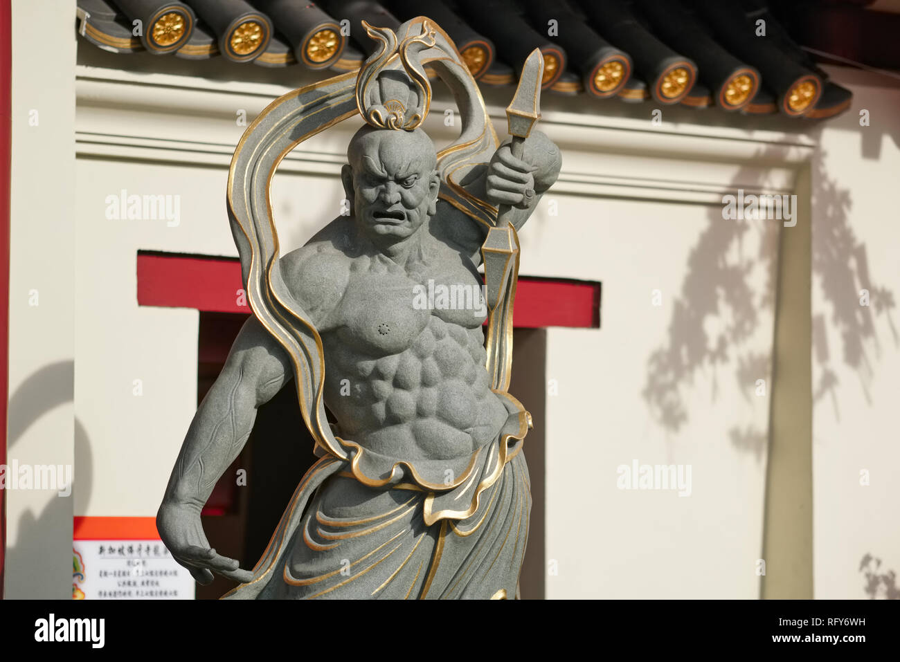 A fierce temple guardian statue outside the Buddha Tooth Temple and ...