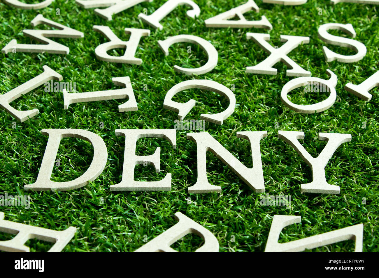 Wording deny on artificial green grass with another english alphabet ...