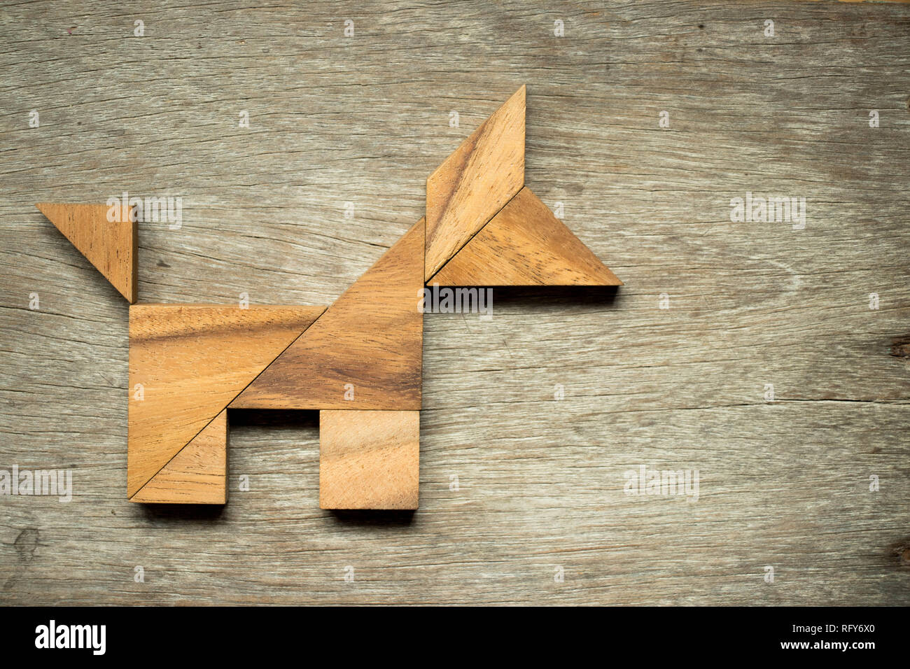 Tangram puzzle in dog shape on wooden background Stock Photo - Alamy