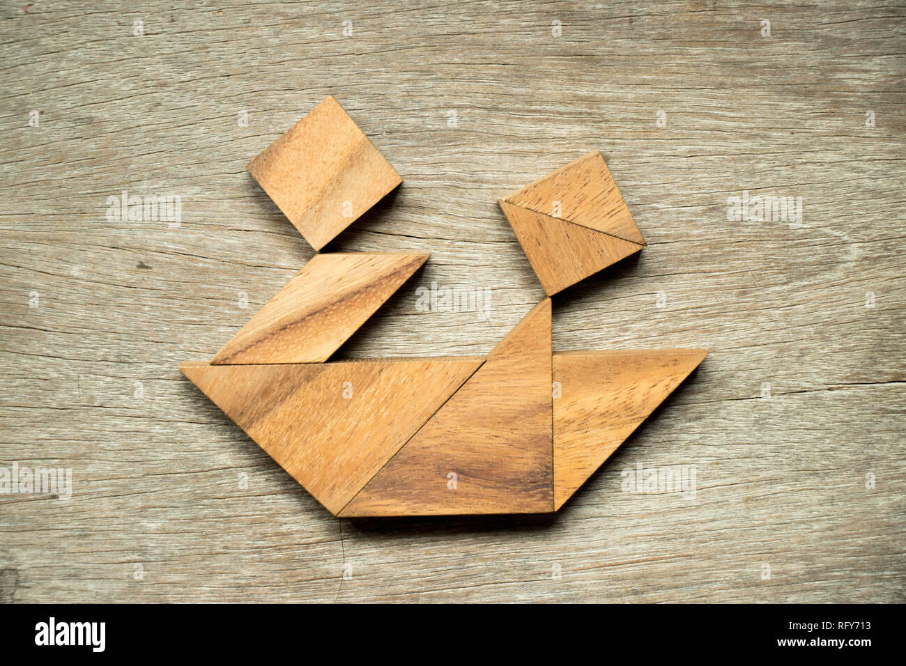 Wooden tangram puzzle in couple sailing the boat shape background ...