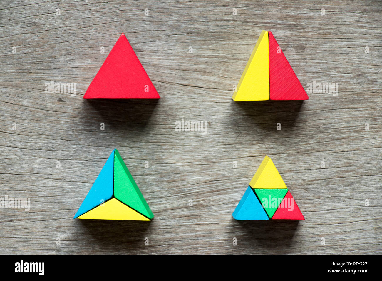 Mulit color toy block compound as triangle shape on wood background ...