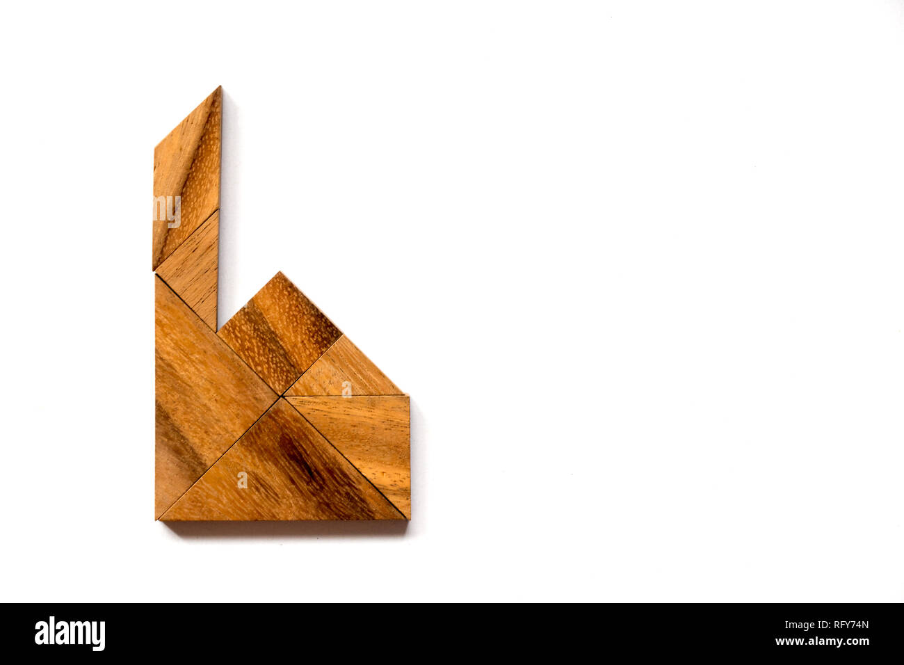 Wooden tangram puzzle in factory or home shape on white background ...
