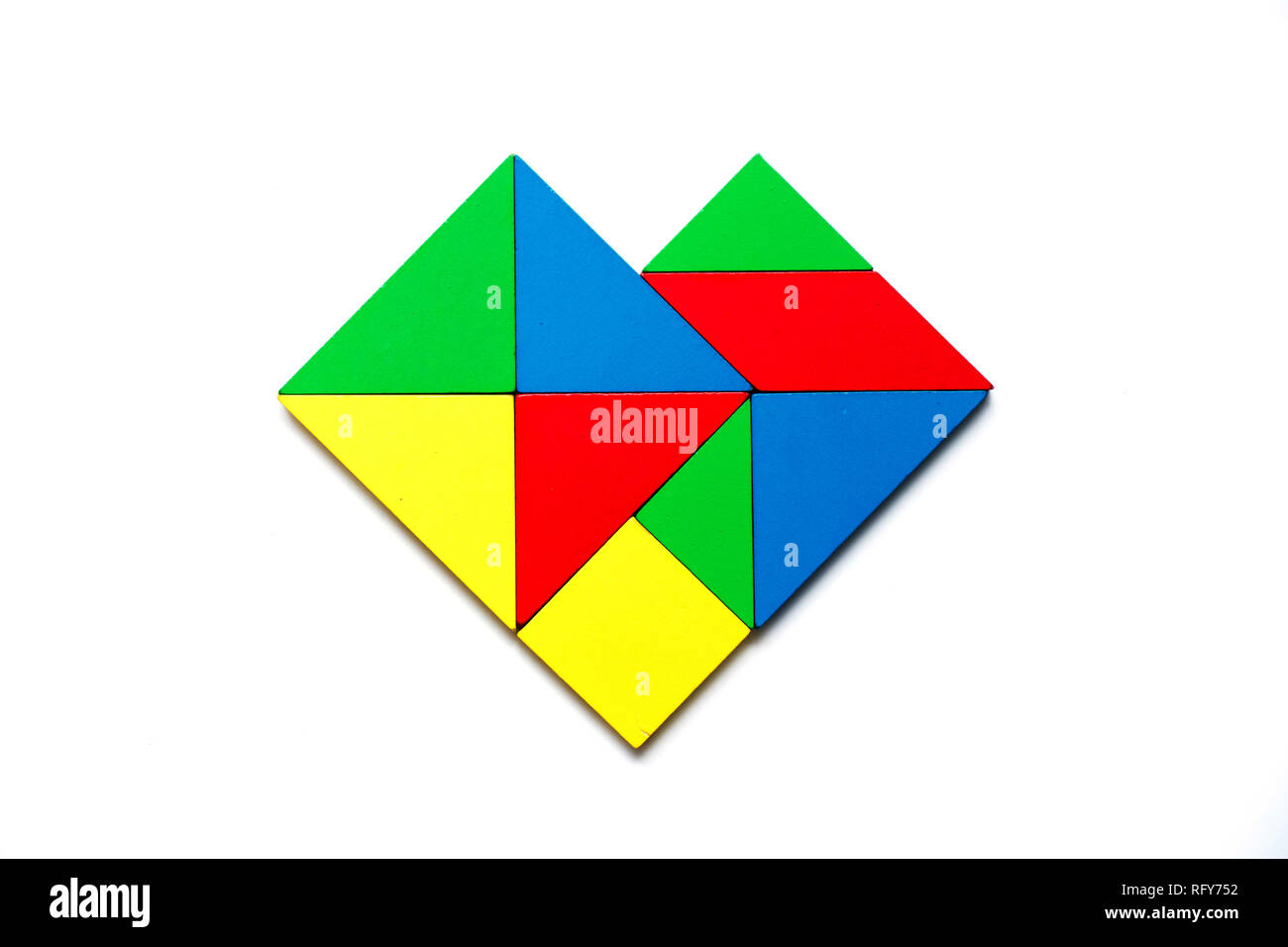 Colorful wood toy puzzle in geometric heart shape on white background ...