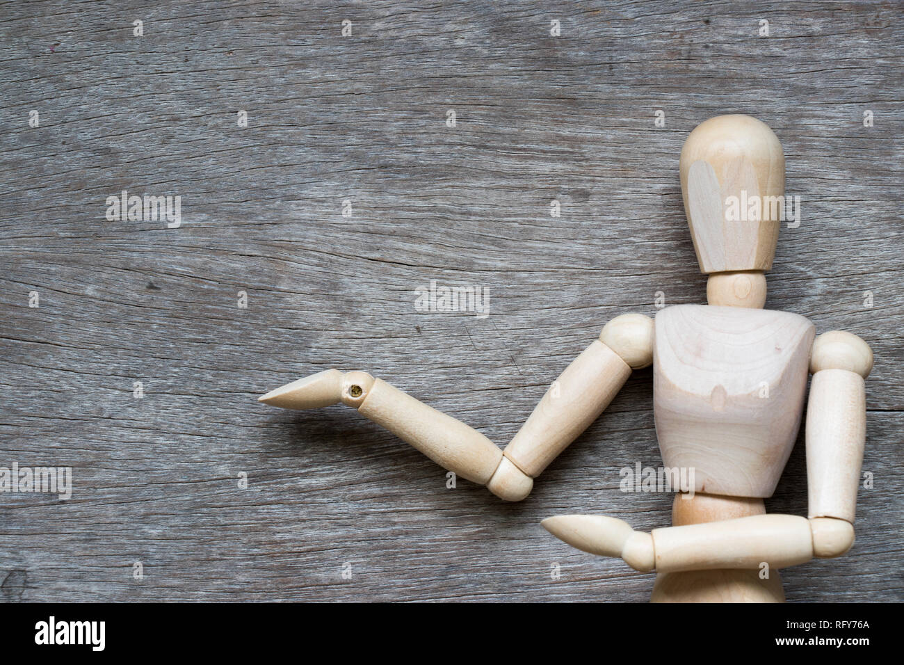 Man figure posing in presentation on wooden background with copy space ...