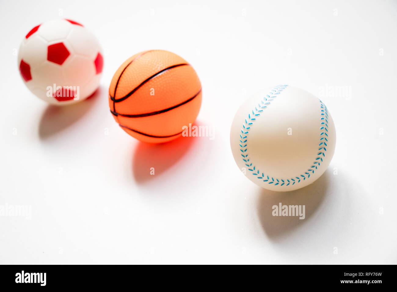Group of football, baseball and basketball placed on white background ...