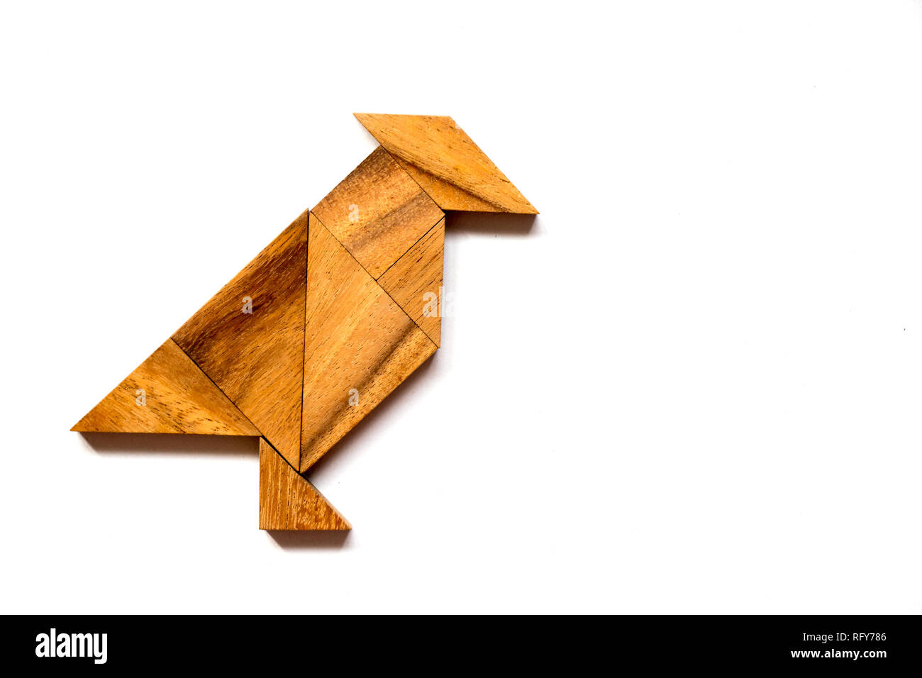 Wooden tangram puzzle in bird shape on white background Stock Photo - Alamy
