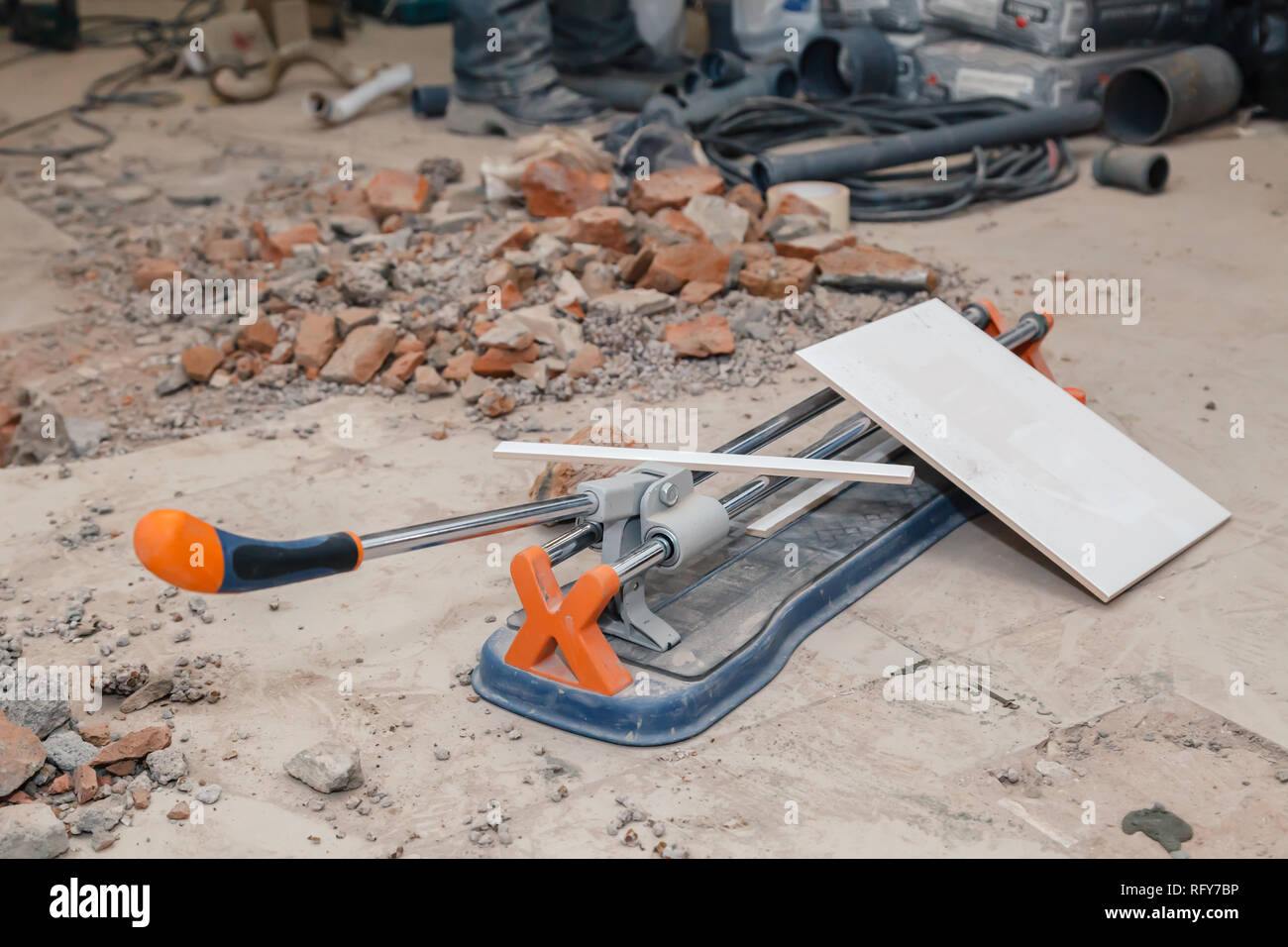 Closeup professional metal construction tile cutter and lying on the ...