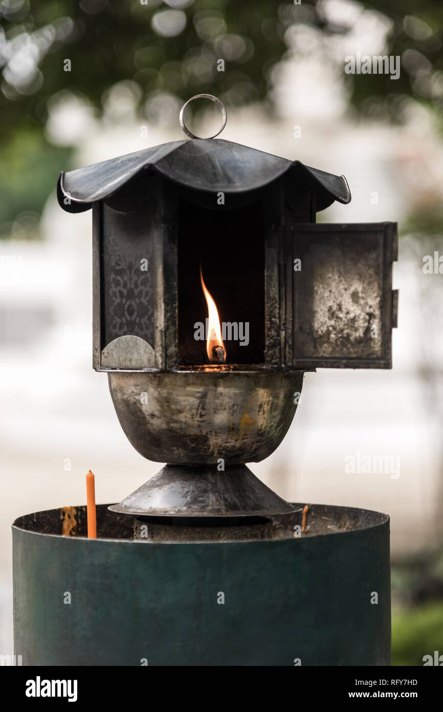 Traditional oil lamp lit at the buddhist temple Stock Photo - Alamy
