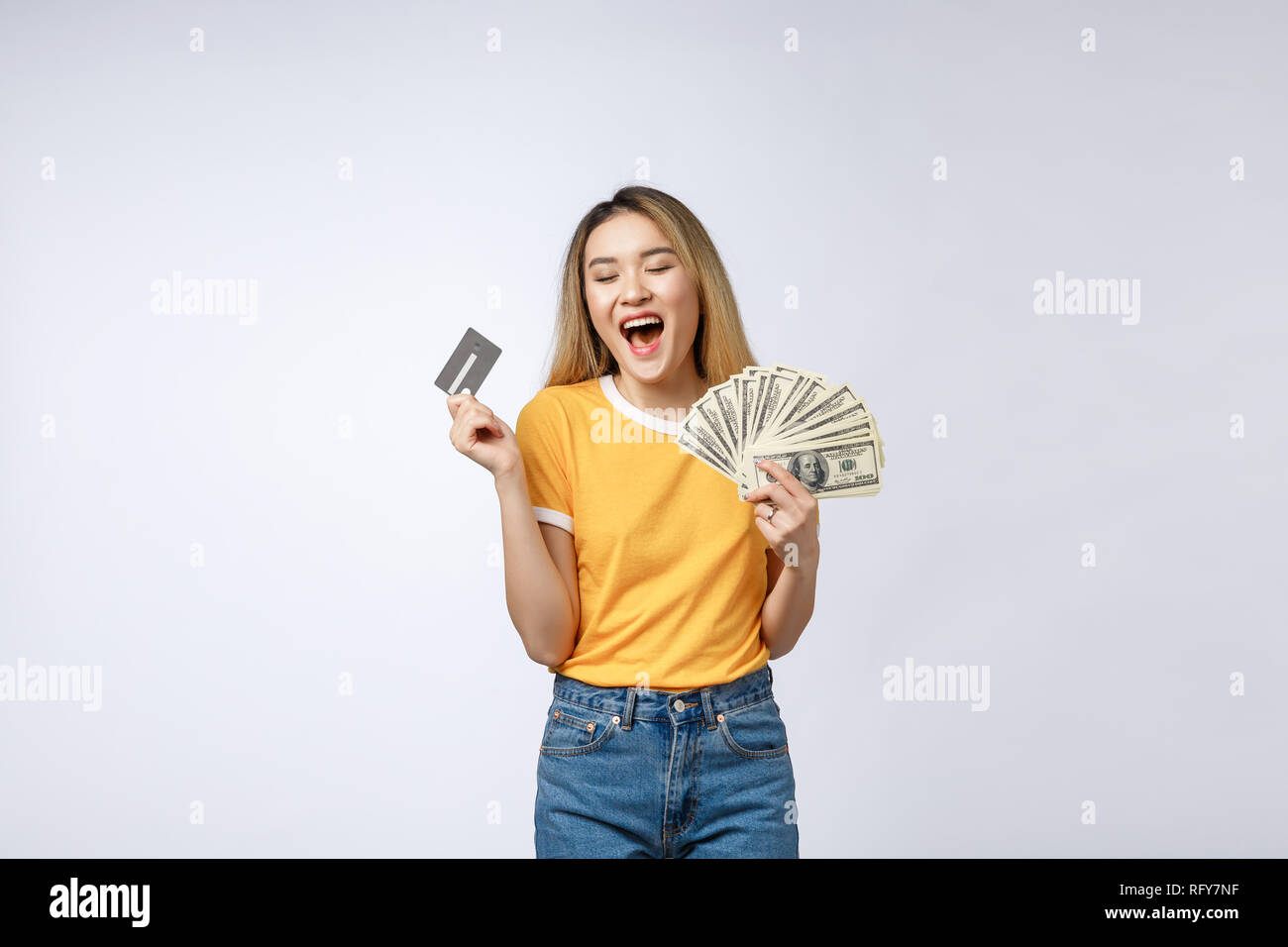 Asian content woman holding fan of money dollar banknotes and credit ...