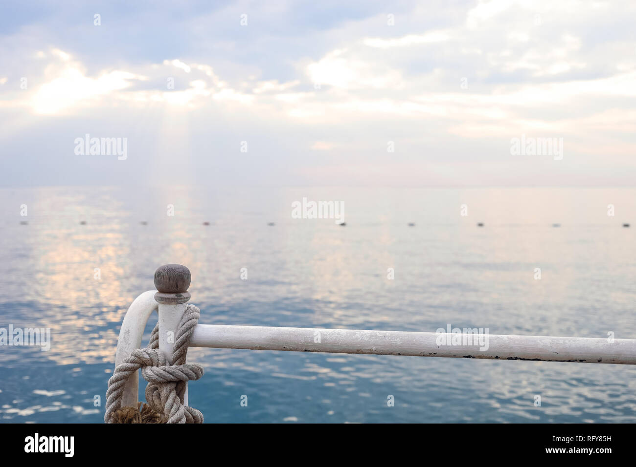 Summer seascape on sunrise and metal railing in foreground Stock Photo ...