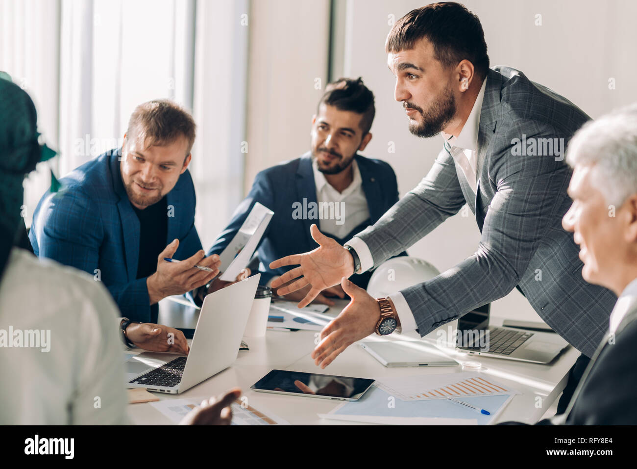 Corporate interracial business team with cheerful leader in a meeting ...