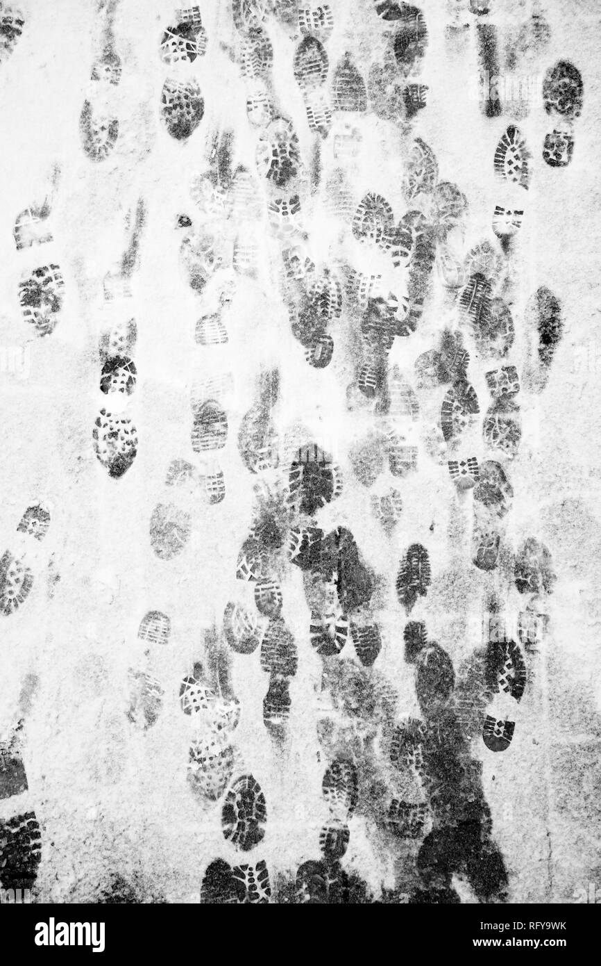 Shoe prints on winter sidewalk covered with snow Stock Photo - Alamy