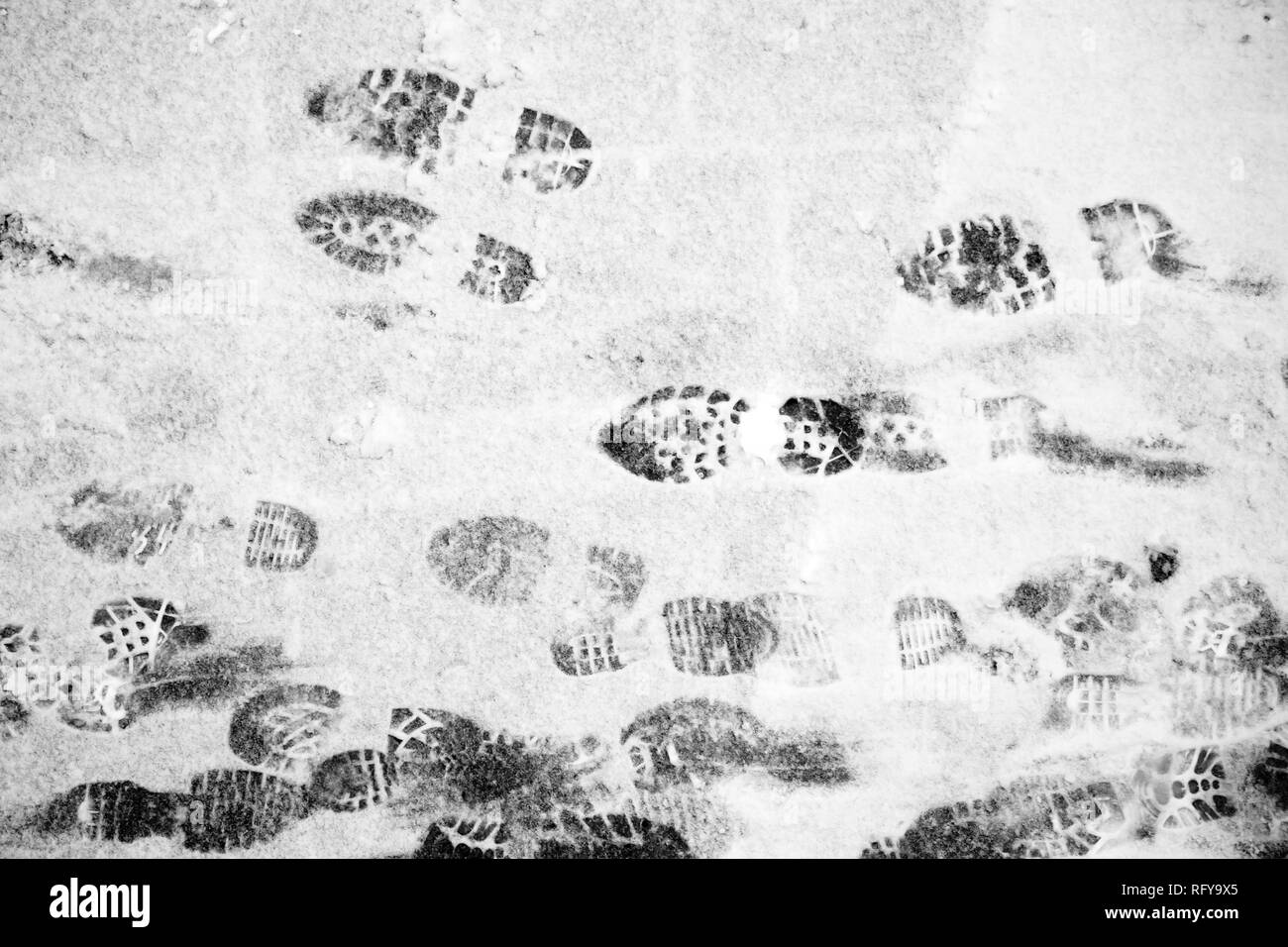Shoe prints on winter sidewalk covered with snow Stock Photo - Alamy