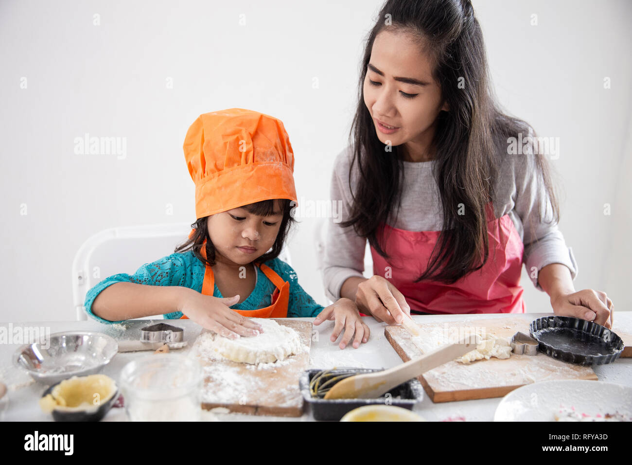 enjoy making cake with mom in the kitchen Stock Photo - Alamy
