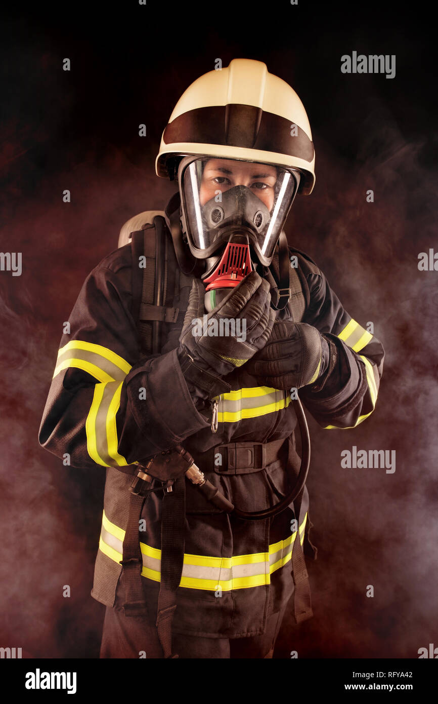 Firefighter with mask and protective suit Stock Photo - Alamy