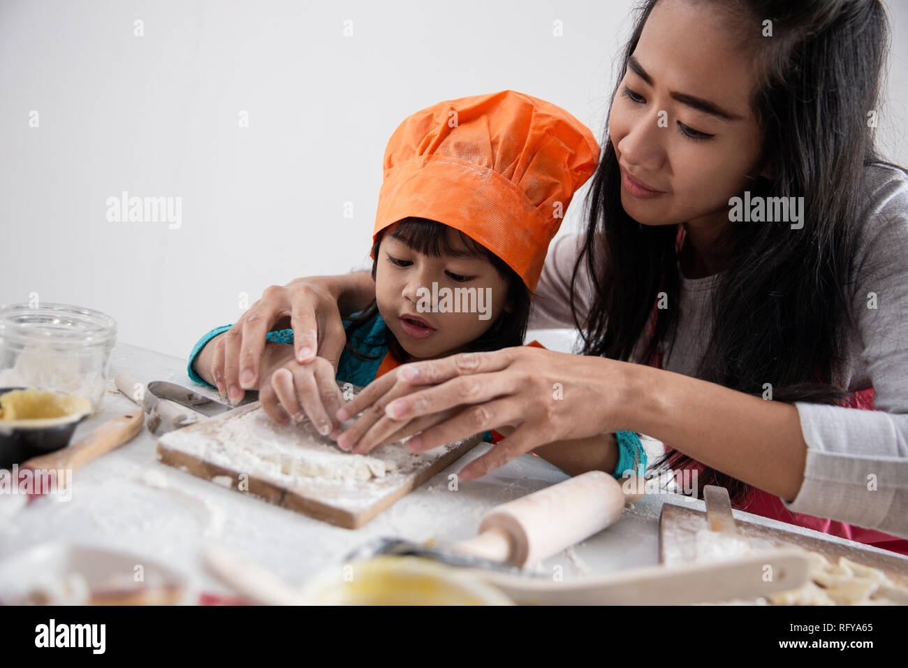 enjoy making cake with mom in the kitchen Stock Photo - Alamy