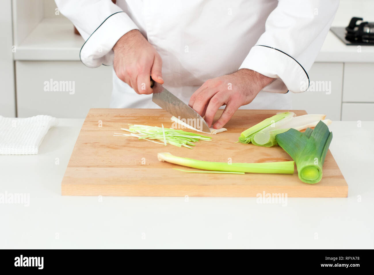 Chef cutting leek with julienne technique Stock Photo - Alamy
