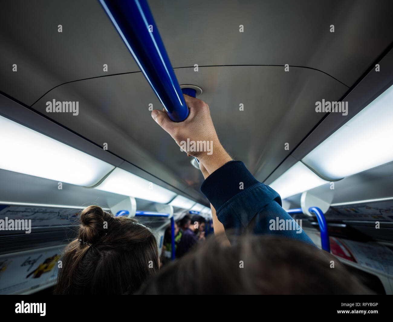 Crowd of people during rush hour in London Tube subway interior, London ...