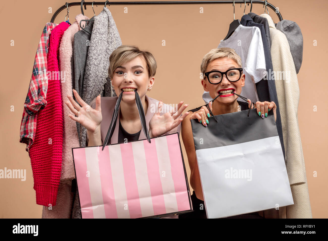funny shoppers with shopping bags in their teeth Stock Photo - Alamy