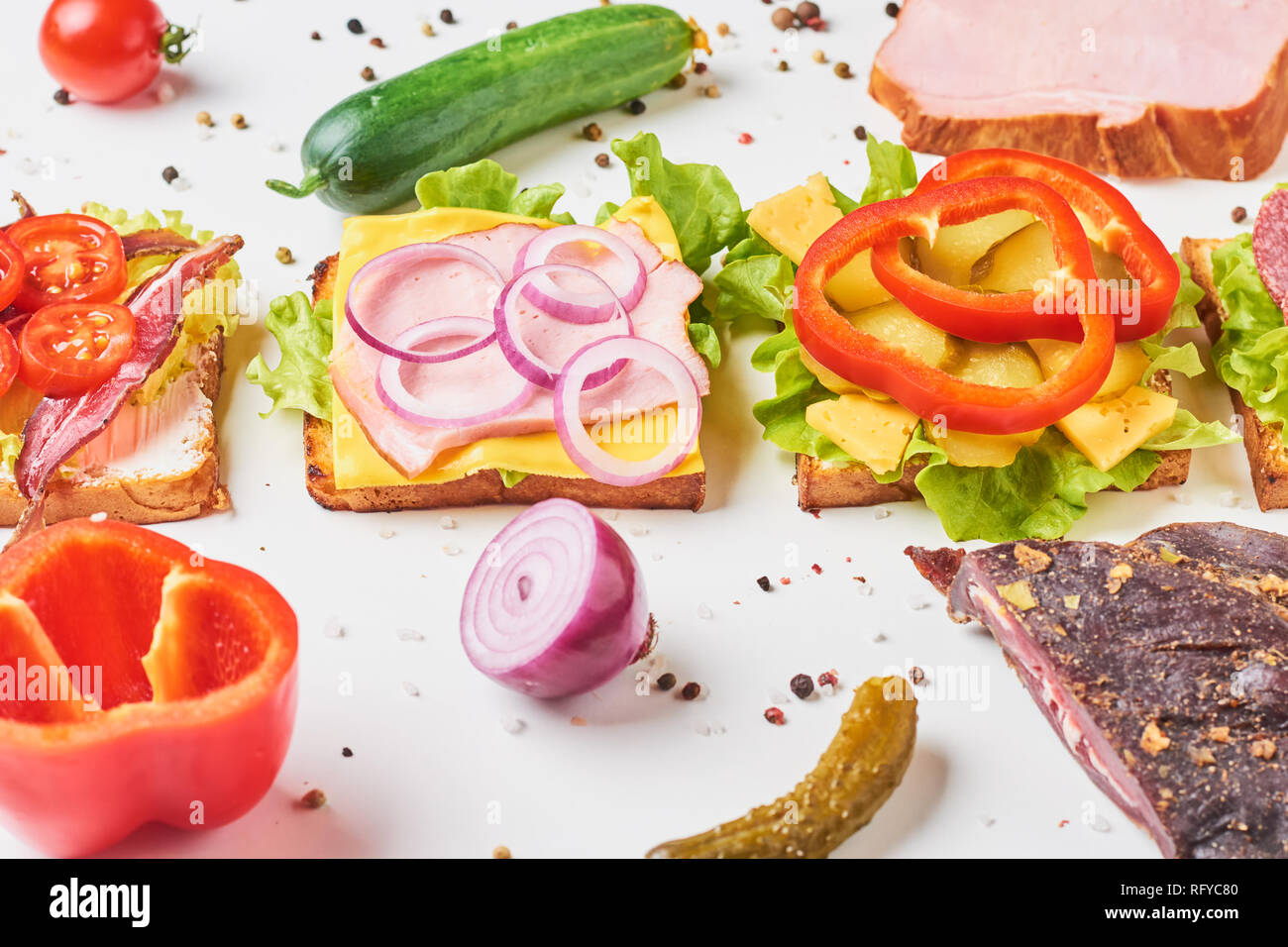 Different kind of sandwich and ingredients on white background, close ...