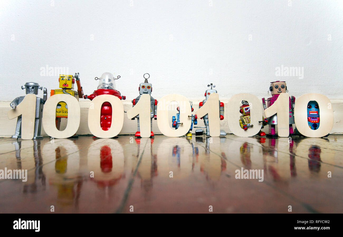 a line of retro bots on a wooden floor with 0,s and 1,s binary code ...