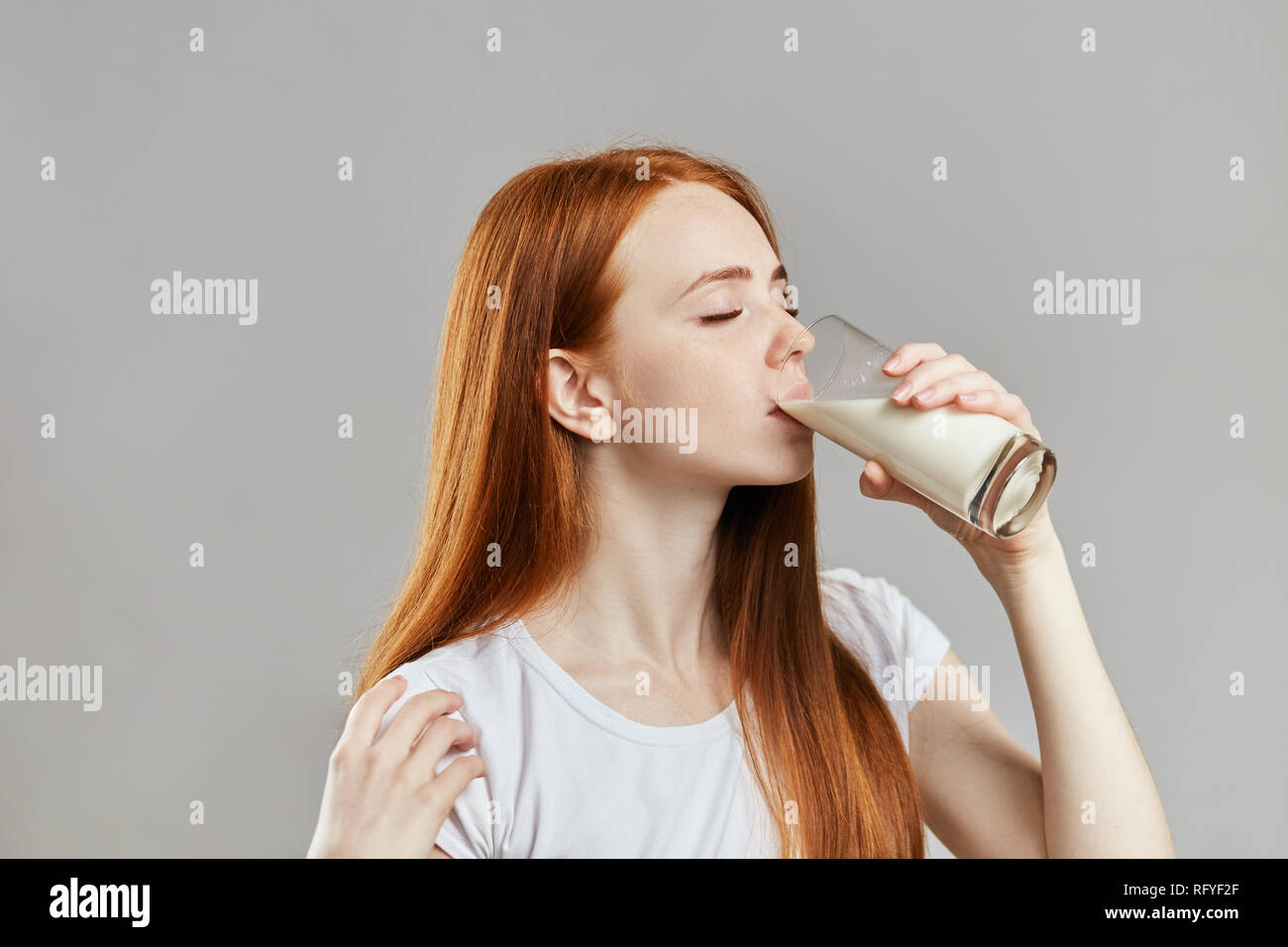 close up side view photo. woman istaking a sip of milk Stock Photo - Alamy