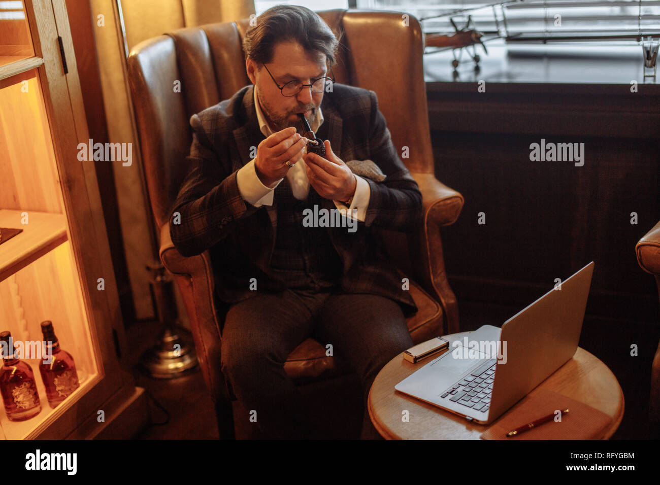 Creative editor pondering over new article, sitting with laptop ...