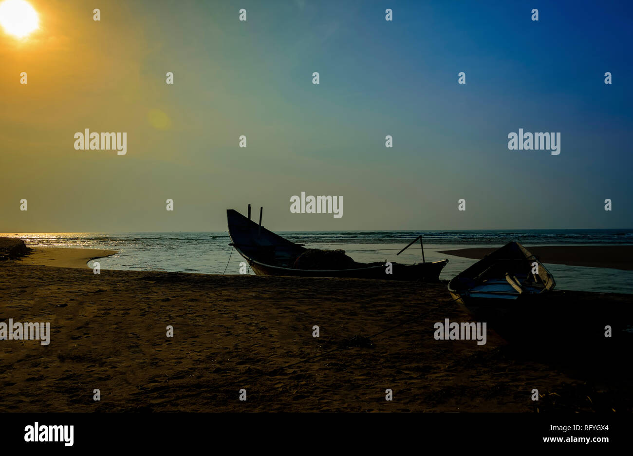 A traditional colourful fishing boat anchored at the confluence of ...