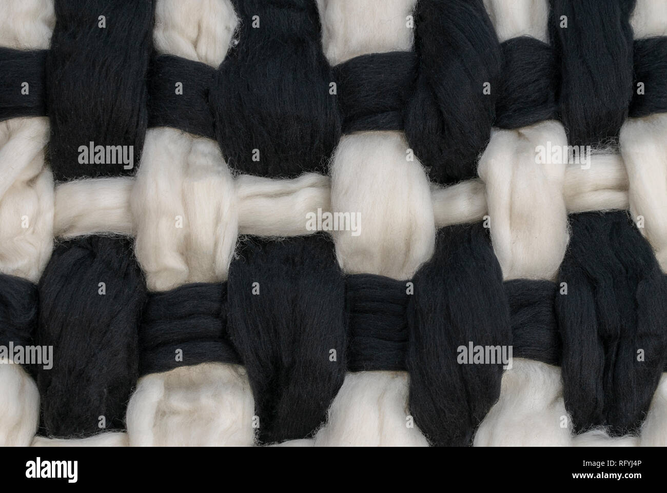 Intertwined black and white tufts of wool. Conceptual photo Stock Photo ...