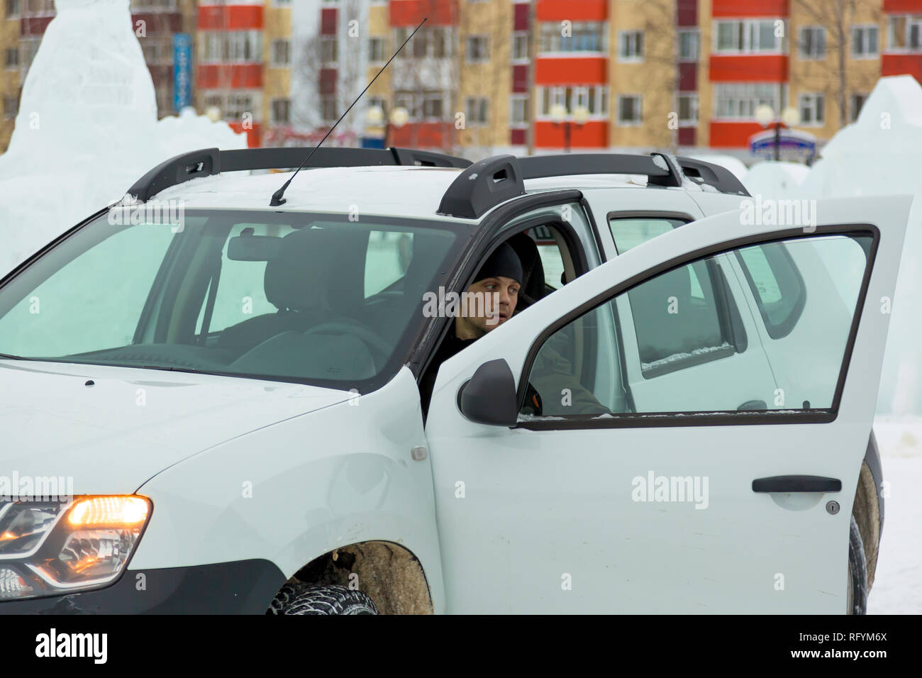 Portrait of the driver in the passenger compartment of the car behind ...