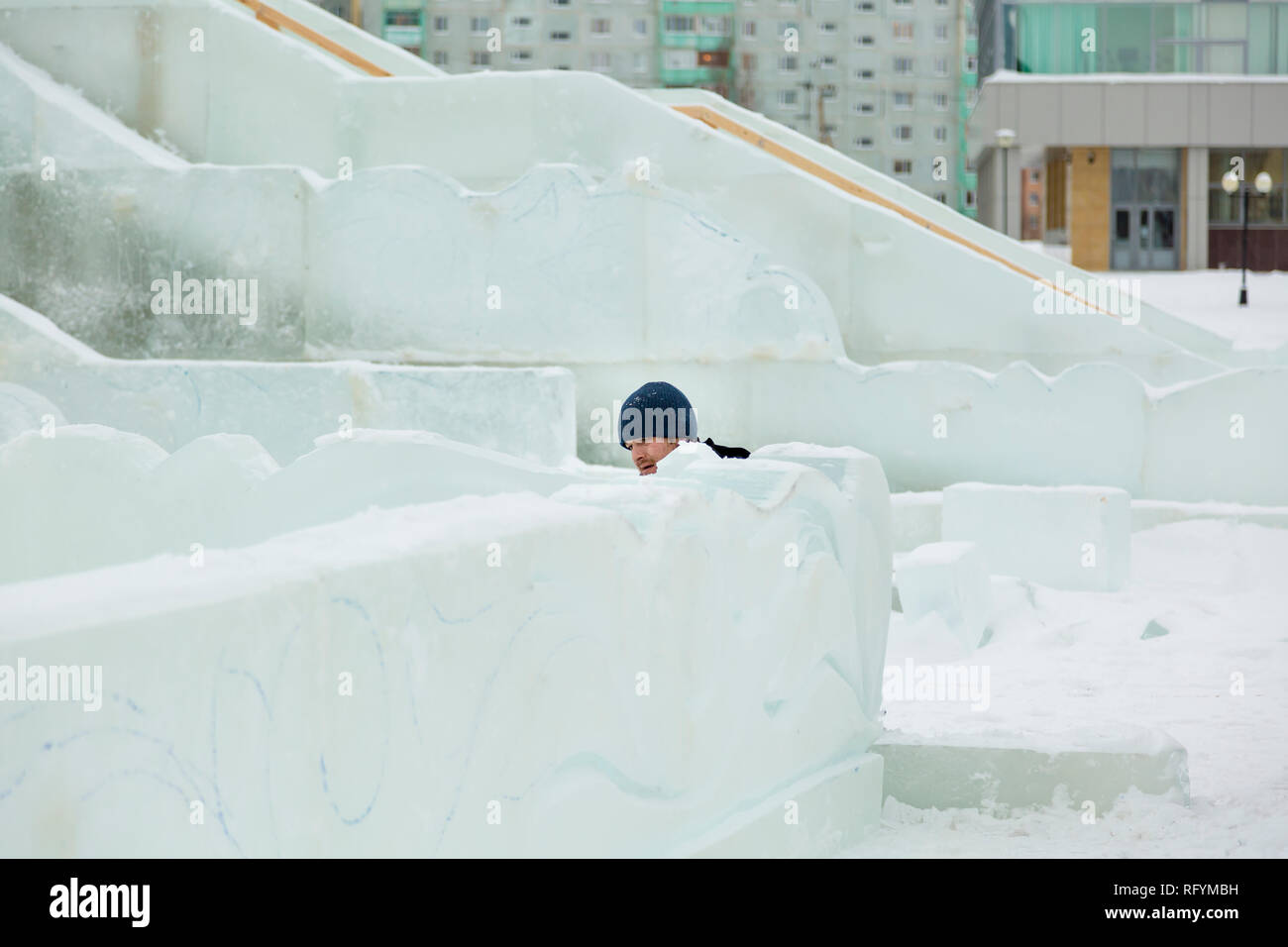 The sculptor cuts an ice figure out of ice with a chisel for Christmas ...